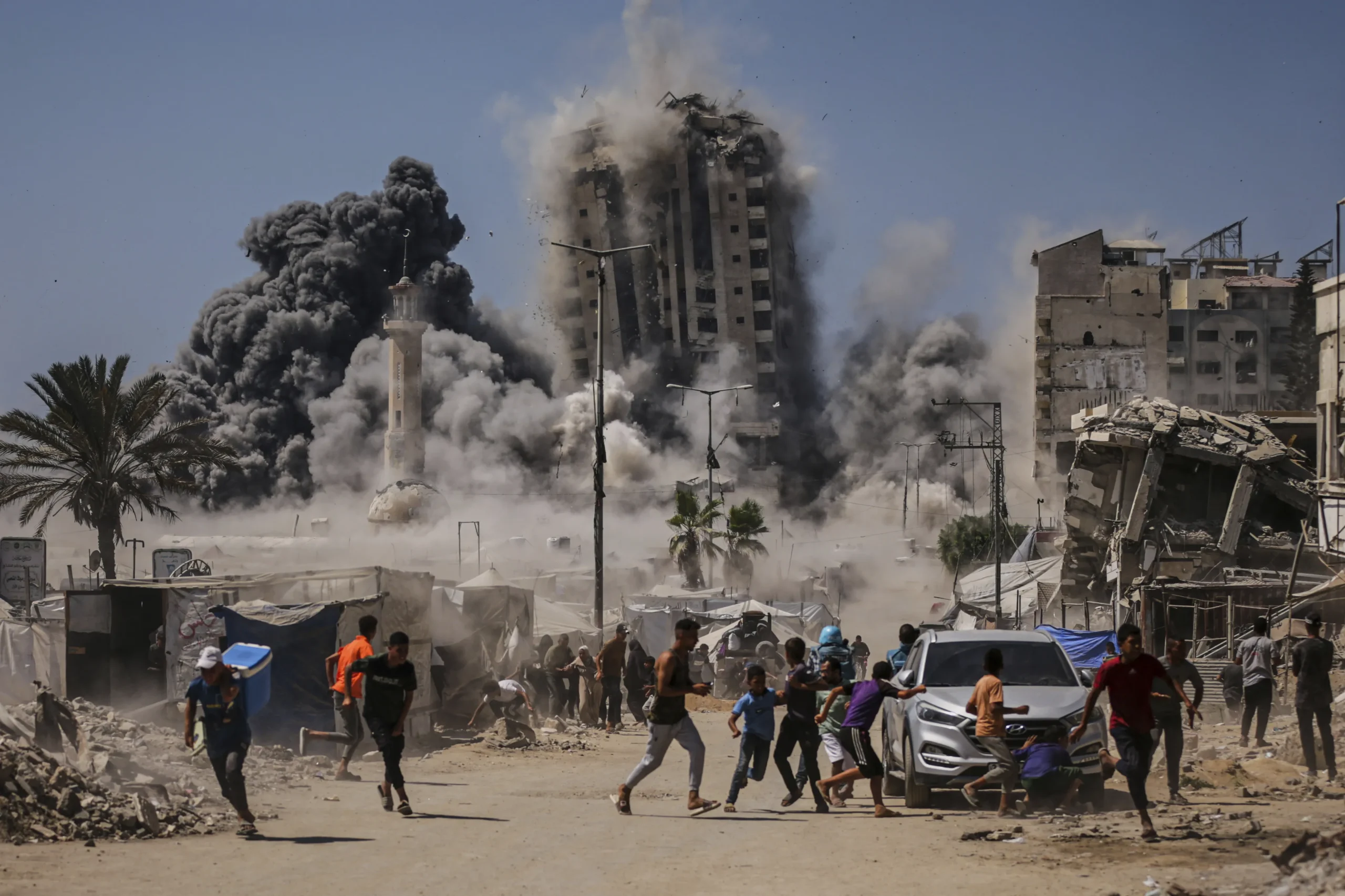Israel strikes high-rise building and threatens to hit more in Gaza ...