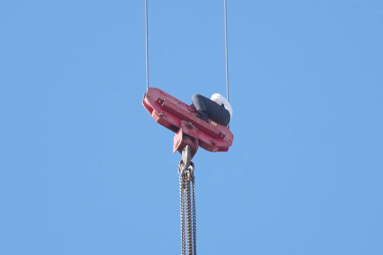 Fire teams rescue 15-year-old stuck on crane over high-rise building in ...
